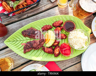 Beef steak with chicken wings and fruits, top view Stock Photo - Alamy
