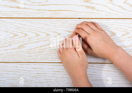 Hands making a gesture on a wooden background Stock Photo - Alamy