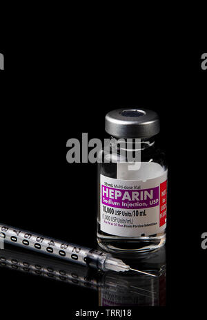 A bottle of the anticoagulant drug Heparin Sodium with a Syringe on a ...