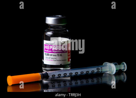 A bottle of the anticoagulant drug Heparin Sodium with a Syringe on a ...