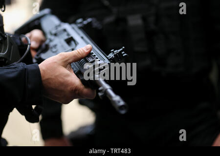 Military man. He is holding an automatic weapon. He has big muscles ...