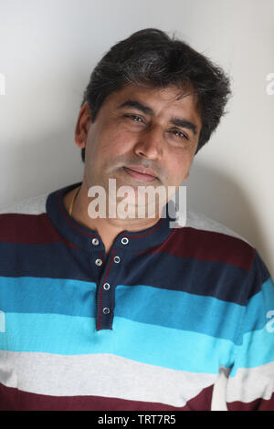 Sad and gloomy man sulking, looking bored at upper left corner ...