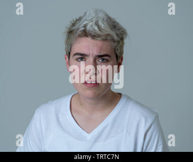 Portrait of young attractive transgender teenager man with angry face ...