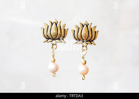 pearl beads lotus shape earrings on neutral background Stock Photo - Alamy