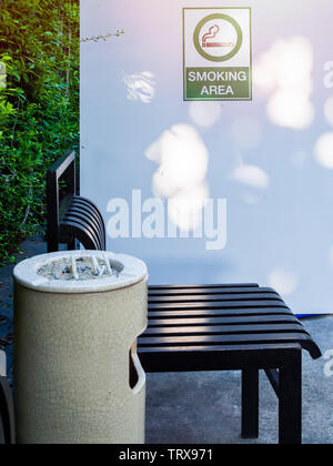 Designated smoking area sign and ash tray. Outside an office building ...