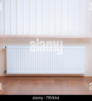 Heating radiator under window Stock Photo - Alamy
