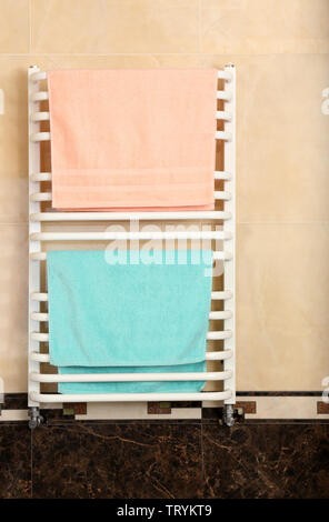 Color towels on radiator in bathroom Stock Photo - Alamy