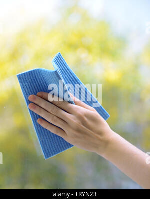 Hands with napkin cleaning window Stock Photo - Alamy