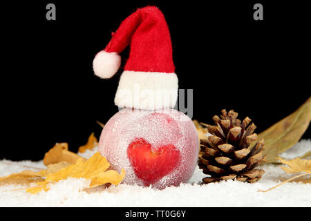 Holiday apple with frosted drawing in snow on black background Stock ...