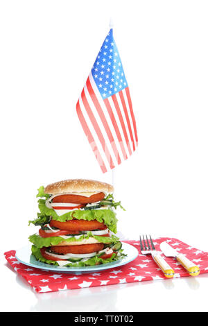 Composition with huge burger on color plate and USA flag, isolated on ...