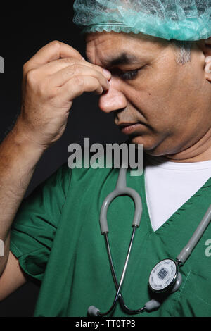 Male surgeon looking at sadness, fatigue after surgery, stress ...