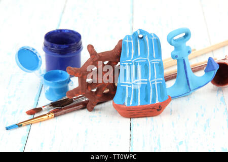 Hand made ceramic toys and color paints on wooden table Stock Photo - Alamy