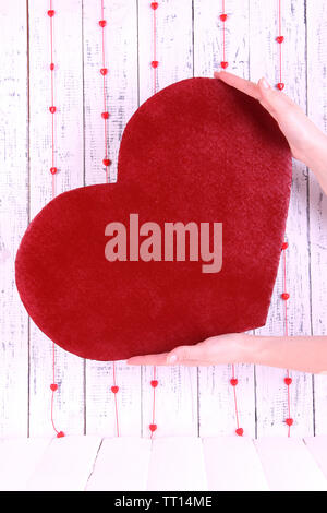 Small girl holding hearts on sticks. Cute girl with red hearts. Child ...