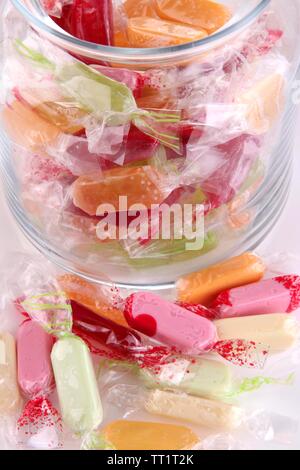 Delicious candies in red wrappers on white background Stock Photo - Alamy