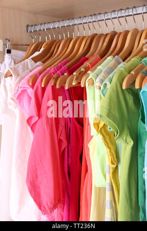 Colorful clothes hanging in wardrobe Stock Photo - Alamy
