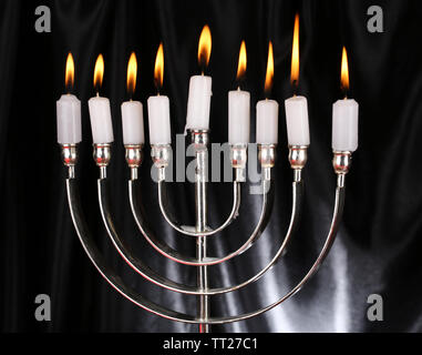 Bronze Hanukkah menorah with burning candles Stock Photo - Alamy