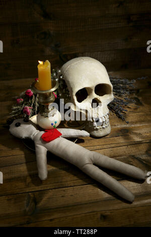 Voodoo doll on a wooden background with dramatic lighting. The concept ...