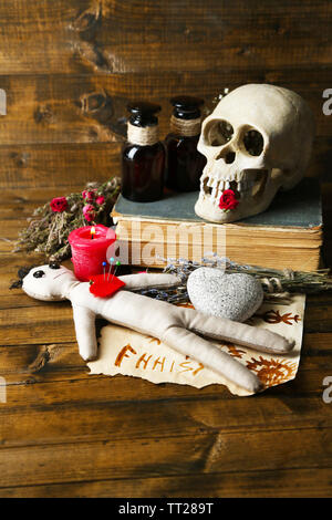 Composition with skull, dried herbs and candle on wooden background ...