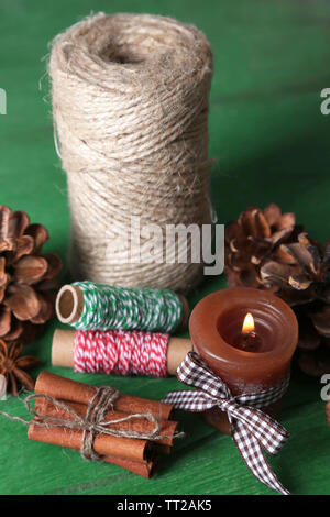 Composition with natural bump, candle, thread, cinnamon sticks on ...