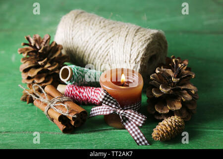 Composition with natural bump, candle, thread, cinnamon sticks on ...