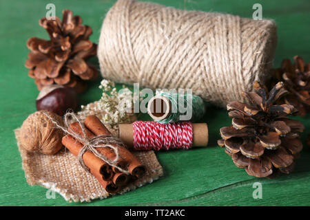 Composition with natural bump, thread, cinnamon sticks on wooden ...