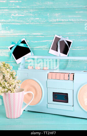 Still life with colorful retro radio, on brick wall wooden background ...