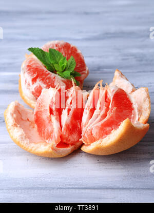 Ripe peeled grapefruits on color wooden background Stock Photo - Alamy