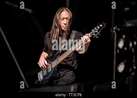 Dream Theater bassist John Myung is shown performing on stage during a ...