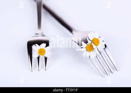 Steel Forks with daisy flower on shiny mirror surface Stock Photo - Alamy