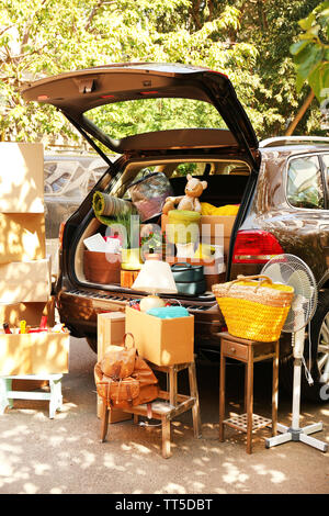 Cardboard boxes in car trunk, Delivery employees working with cardboard ...