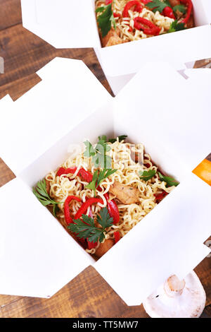 Chinese noodles in takeaway boxes on bamboo mat background Stock Photo ...