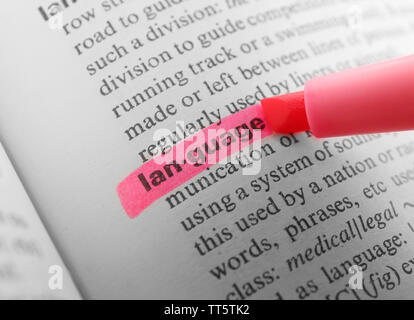 Pink marker highlighting word in dictionary Stock Photo - Alamy