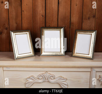 Empty photo frames on chest of drawers in living room, space for text ...