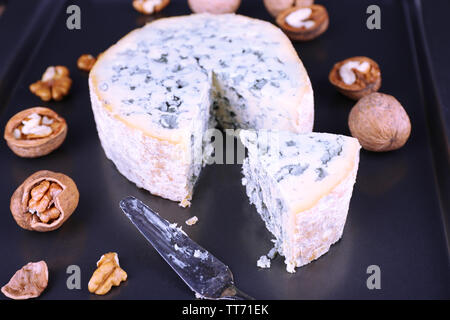 Blue cheese with nuts and blade on metal tray background Stock Photo ...
