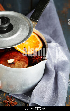Old metal pan of tasty mulled wine on wooden table Stock Photo - Alamy