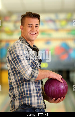 Male with bowling ball in club Stock Photo - Alamy