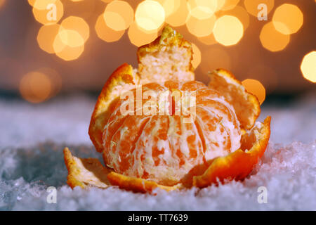 Fresh ripe mandarin on snow, on lights background Stock Photo - Alamy
