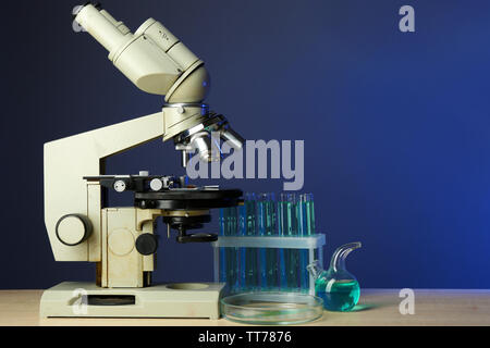 Microscope and test tubes on table, on color background Stock Photo - Alamy