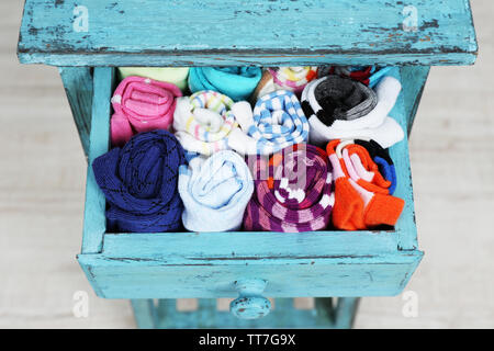 Socks in color drawer on white brick wall background Stock Photo - Alamy