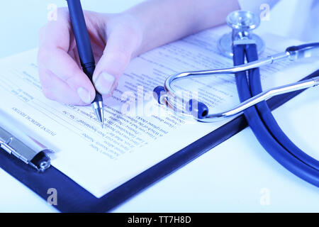Woman filling medical history on light background Stock Photo - Alamy