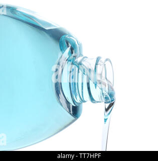 Cosmetic liquid pouring from bottle isolated on white Stock Photo - Alamy