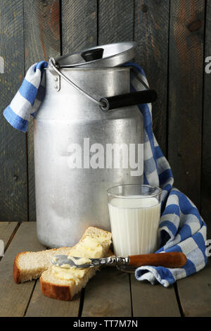 Retro can for milk and fresh bread on wooden table Stock Photo - Alamy