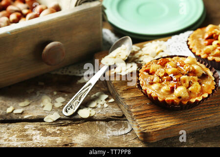 Mini cakes with nuts on wooden background Stock Photo - Alamy
