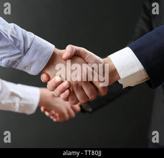 Business handshake on dark background Stock Photo - Alamy
