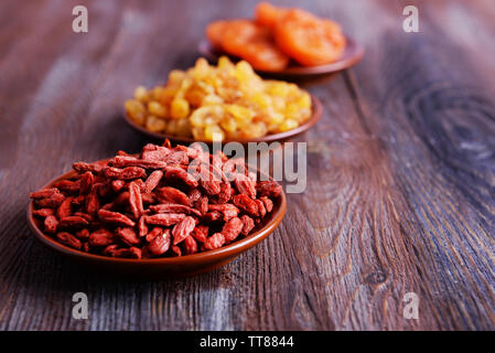 Dried fruits in small plates on rustic wooden table background Stock ...