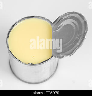 Open tin can with condensed milk isolated on white Stock Photo - Alamy