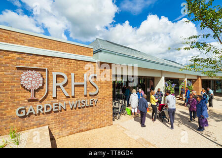 RHS Wisley Gardens entrance & visitors waiting at the sunlit modern new ...