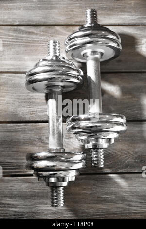 Big dumbbells on wooden background Stock Photo - Alamy