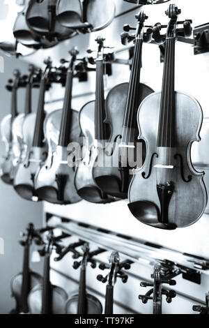Violins hanging on a wall Stock Photo - Alamy