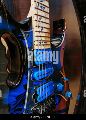modern electric guitar with tree of life neck inlay, isolated on stone ...
